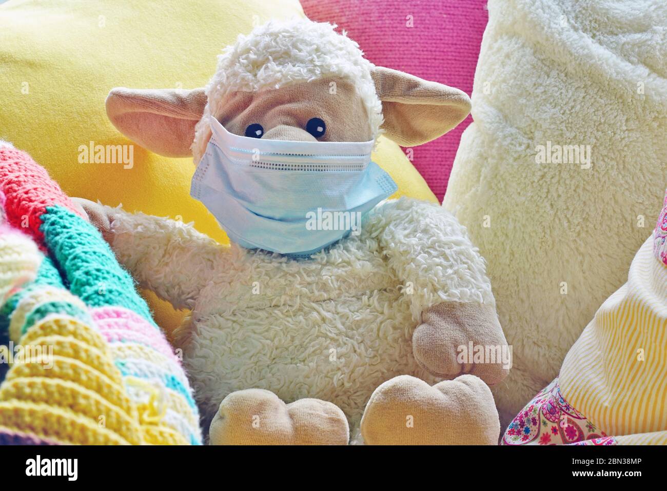 A childrens plush stuffed animal toy wearing a face mask during the ...