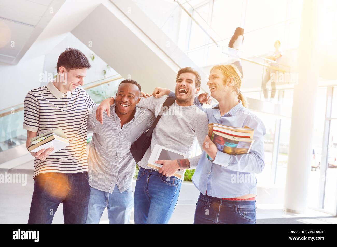 Happy students laugh together as a team in the university Stock Photo ...