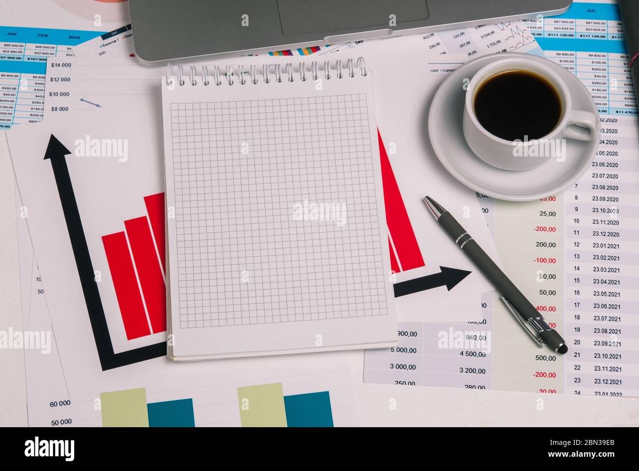 Notebook, pen, and graph with profit growth and numbers. Desk of a ...