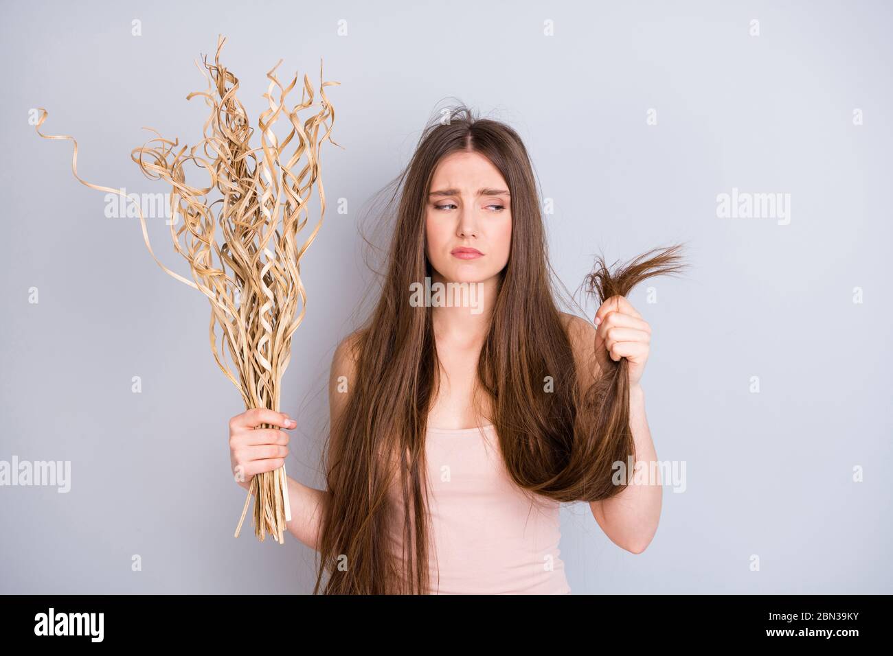 Photo of attractive stressed lady hold dry low hydration balance hairdo ...