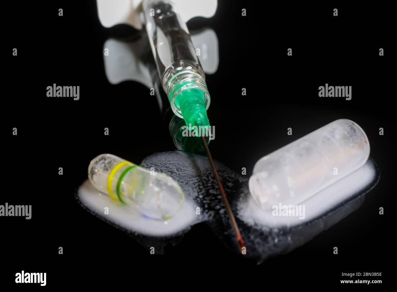 Macro close up of isolated syringe with injection needle, broken glass ...