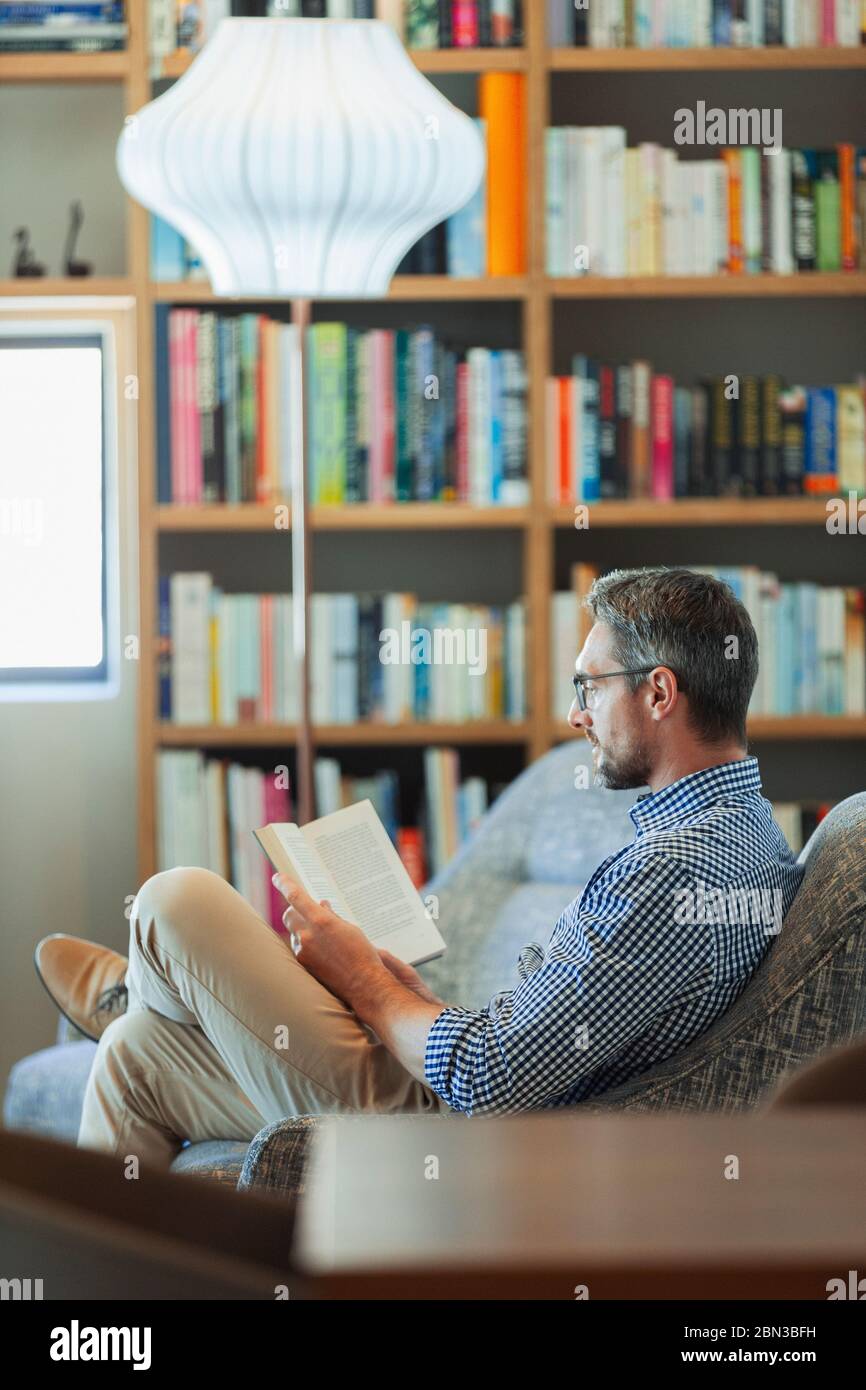 Man relaxing, reading book Stock Photo - Alamy