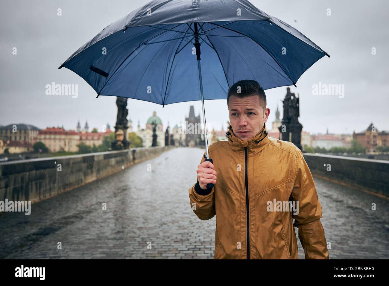 Man walking in rain umbrella hi-res stock photography and images - Alamy