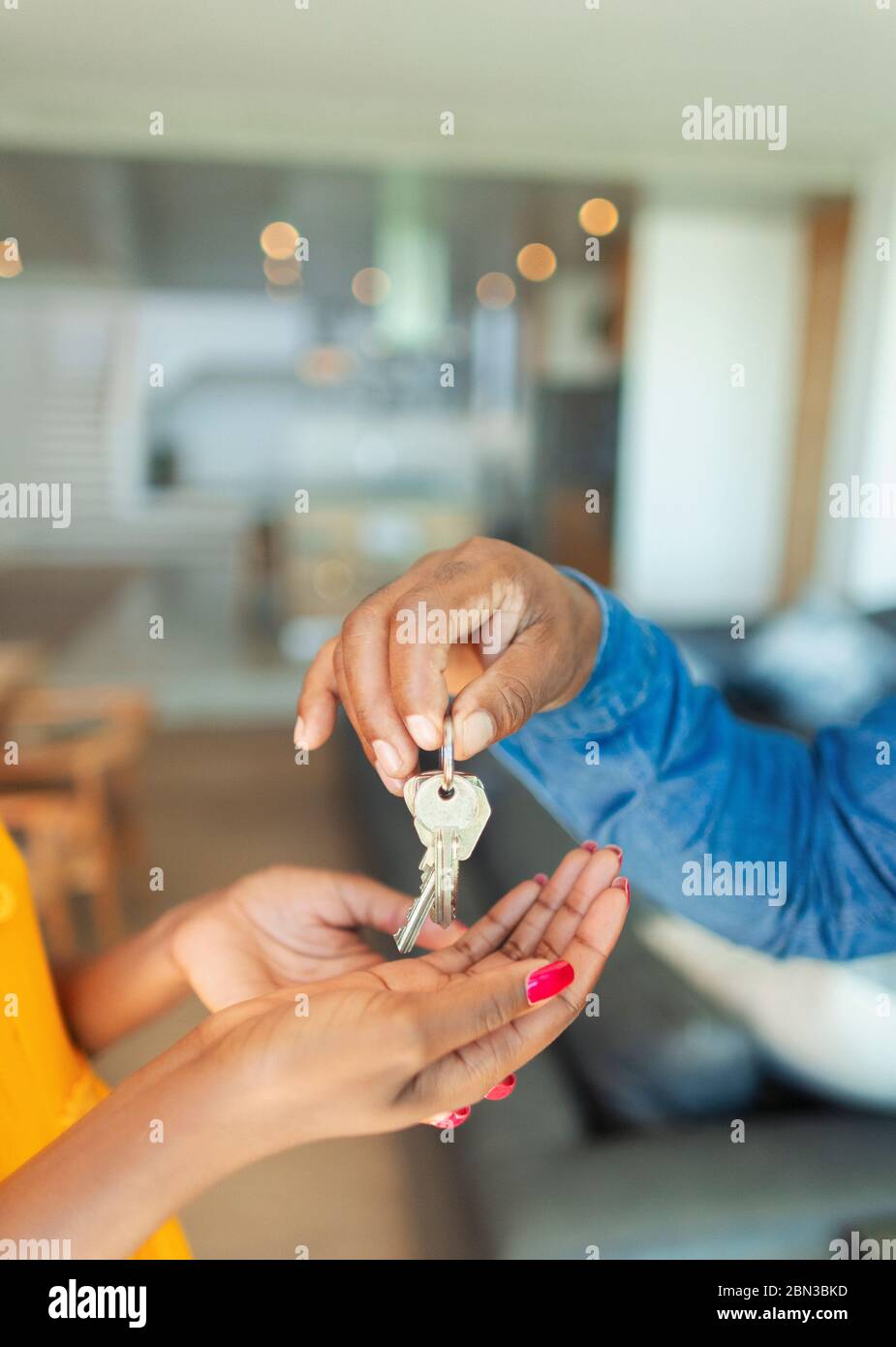 Close up man handing house keys to woman Stock Photo - Alamy