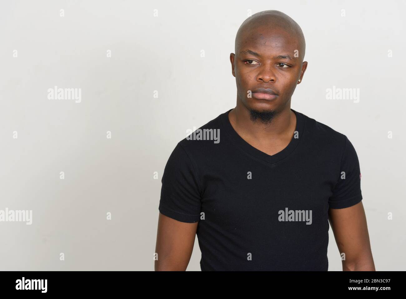 Young handsome bald African man thinking and looking away Stock Photo ...