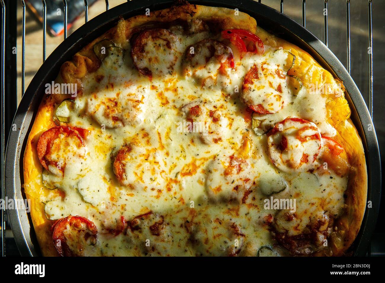 Pizza baked in the oven. A view from behind the oven to a baked pizza ...