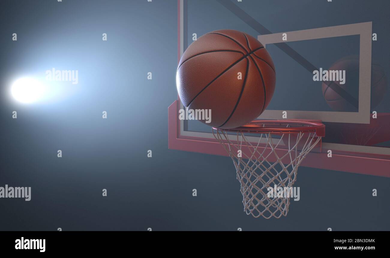 An action shot of a regular basketball teetering on the rim of a red ...