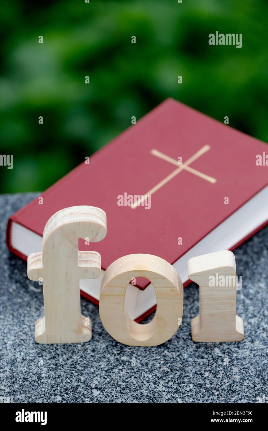 Wooden letters forming the word Foi ( Faith ) and Bible. Christian ...