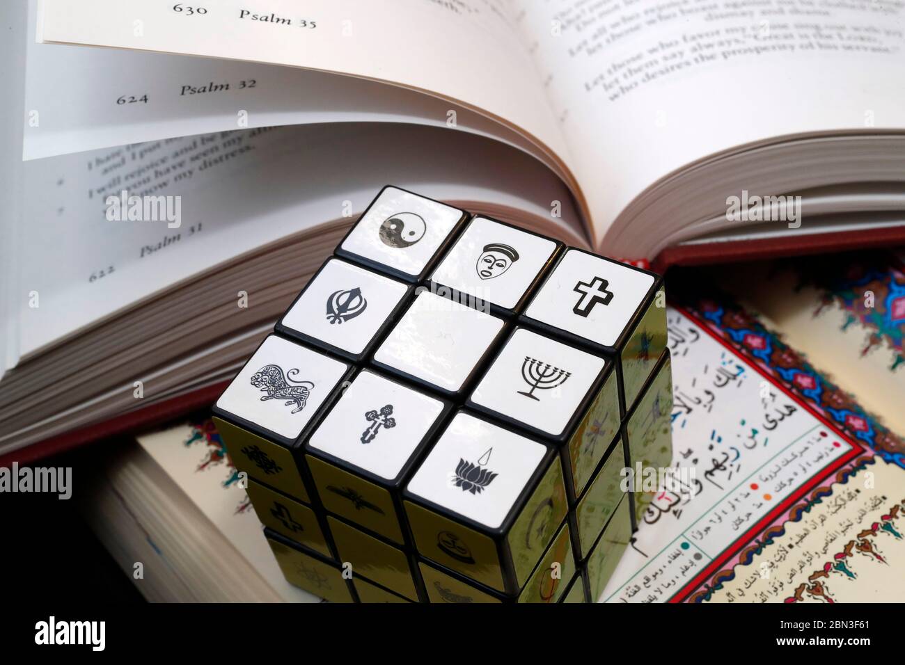 Quran, Bible and Rubik's cube with religious symbols. Interreligious ...
