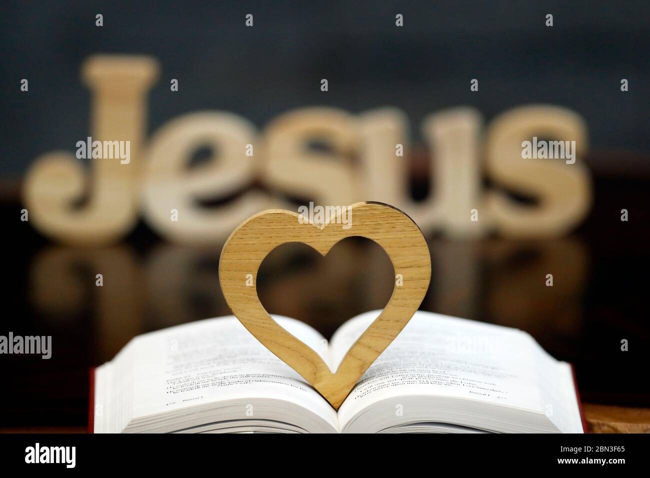 Wooden letters forming the word Jesus with Bible and heart. Christian ...