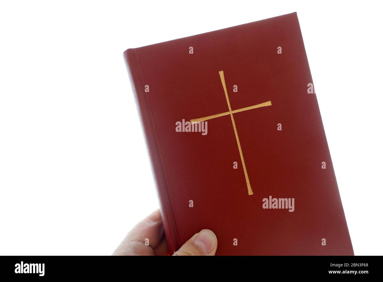 Close up of hand with a red bible. Christian symbol Stock Photo - Alamy