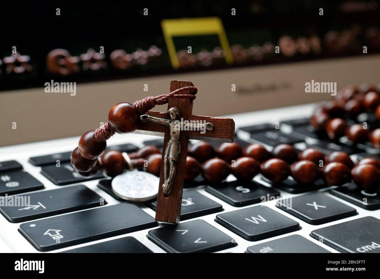 Catholic rosary beads on a laptop keyboard Stock Photo - Alamy