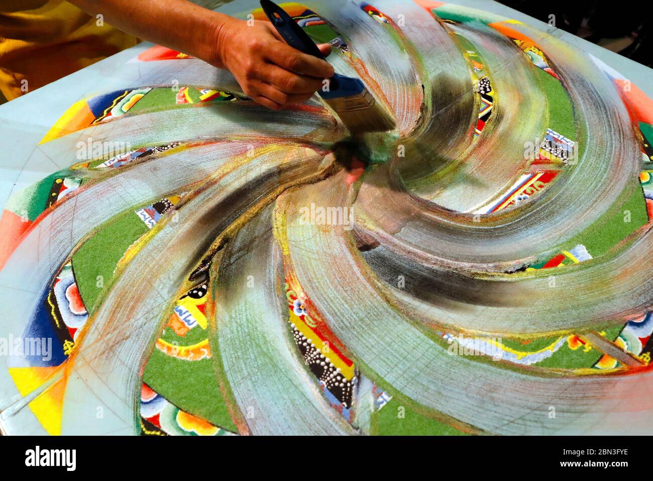 Tibetan Buddhist sand mandala. Bodhisattva Vajrasattva. A Tibetan monk ...