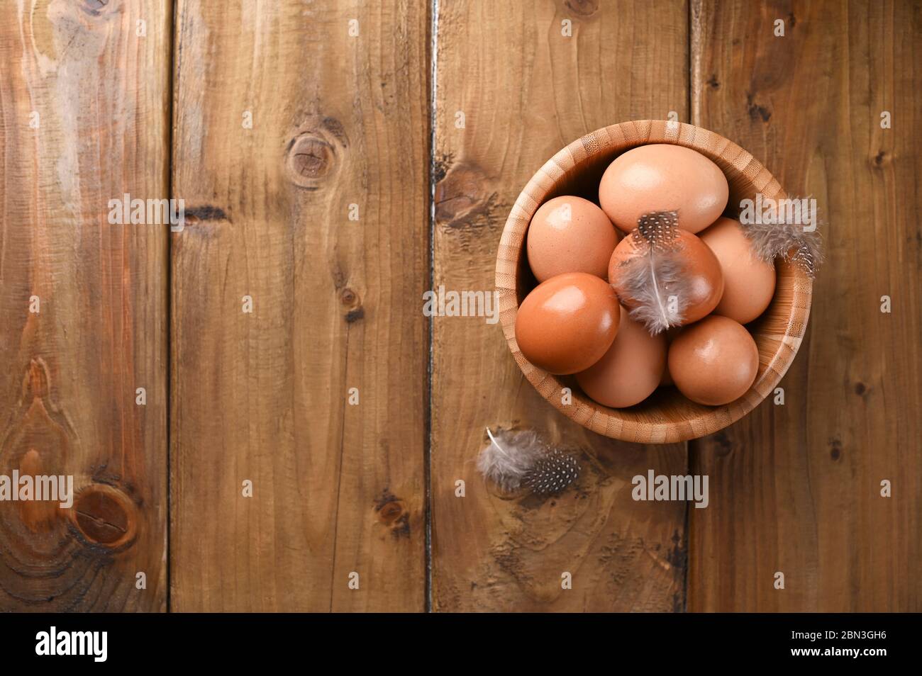 rustic eggs, from homemade chickens, on a wooden background, with ...