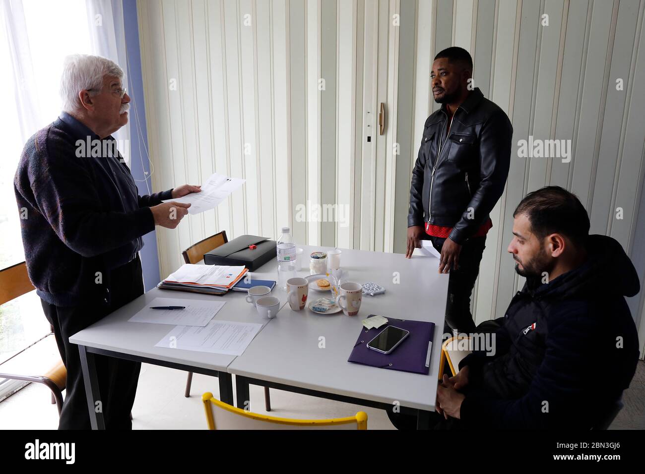 Catholic priest helping migrants with administrative matters in Vernon ...