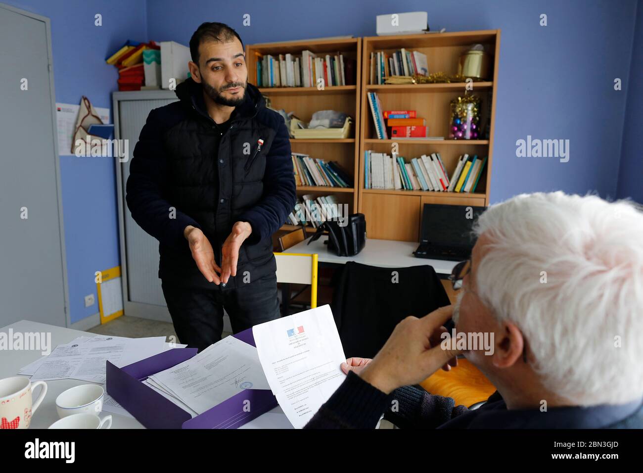 Catholic priest helping migrants with administrative matters in Vernon ...