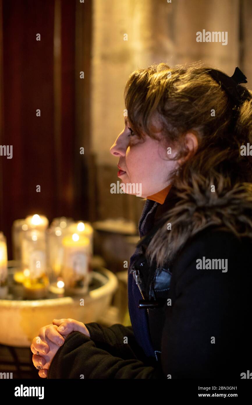 Catholic convert praying in a church in Paris, France Stock Photo - Alamy