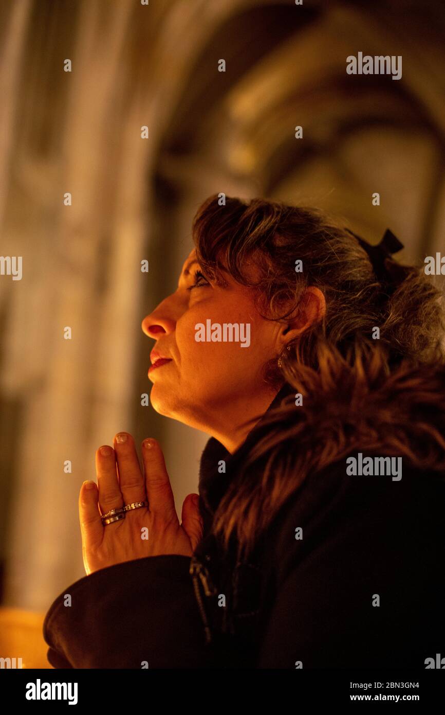 Catholic convert praying in a church in Paris, France Stock Photo - Alamy