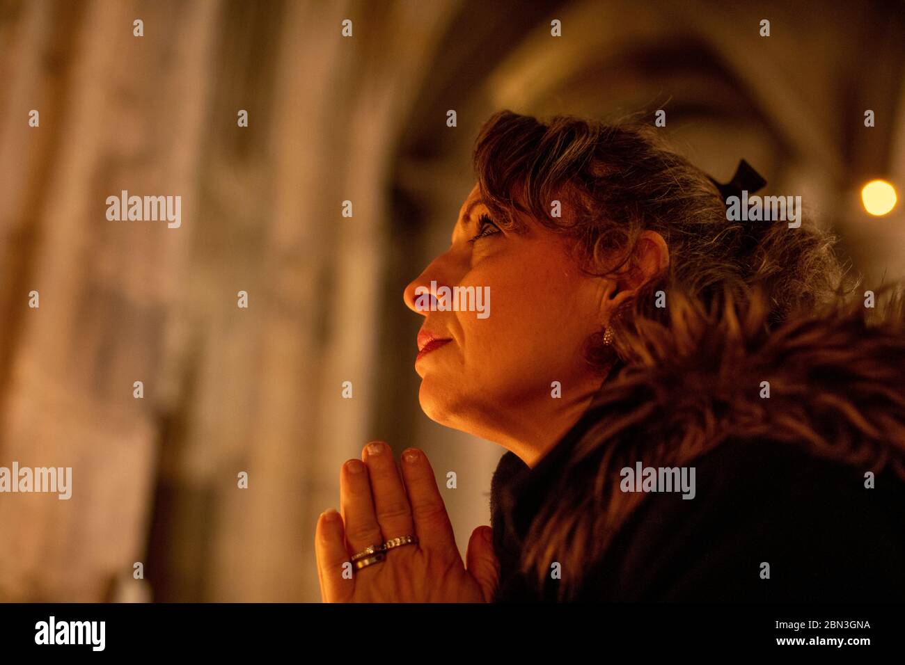 Catholic convert praying in a church in Paris, France Stock Photo - Alamy
