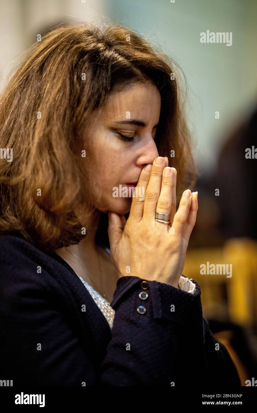 Catholic convert attending mass in Notre Dame du Liban chuch, Paris ...