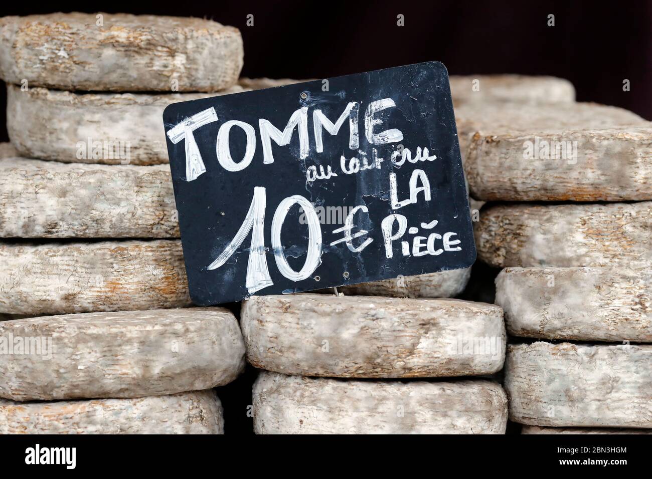 Traditional french cheese for sale at market. Tomme. France Stock Photo ...