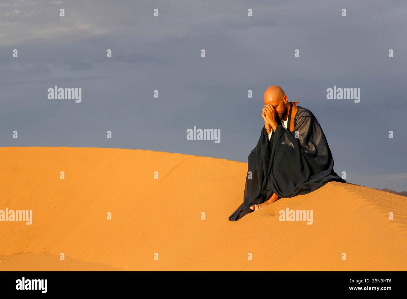 Zen master praying on a dune in the Sahara desert, Morocco Stock Photo ...