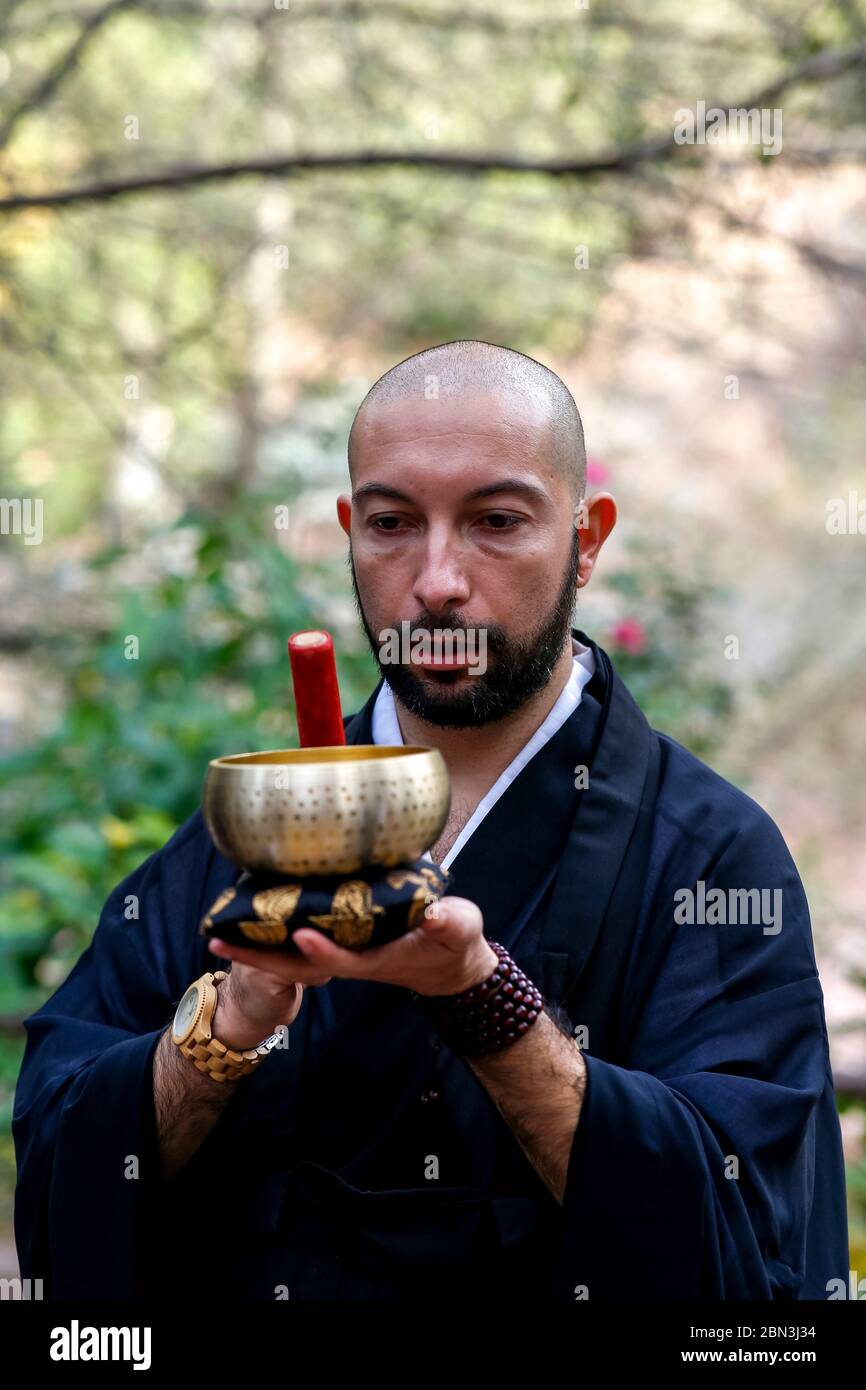Zen monk knocking on a bowl in Morocco Stock Photo - Alamy