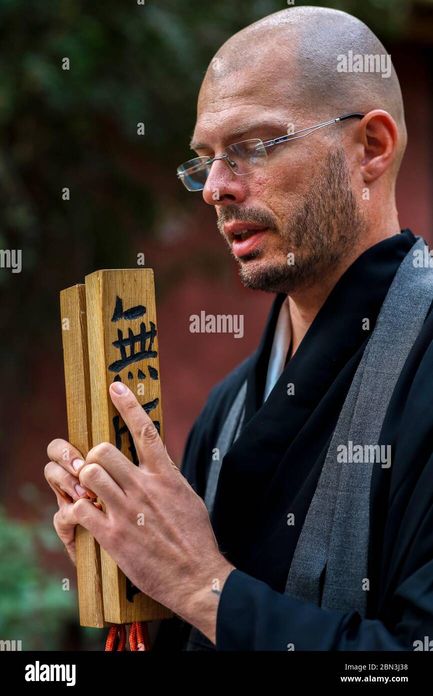Zen monk sounding clappers in Morocco Stock Photo - Alamy