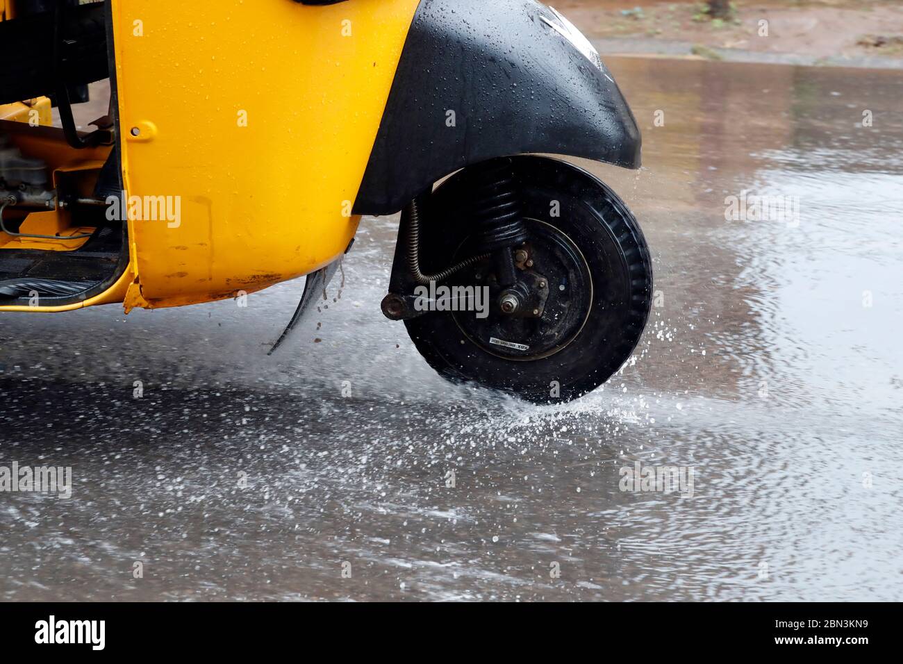 Tuk tuk taxi in heavy rain. Close-up on wheel. Madagascar Stock Photo ...