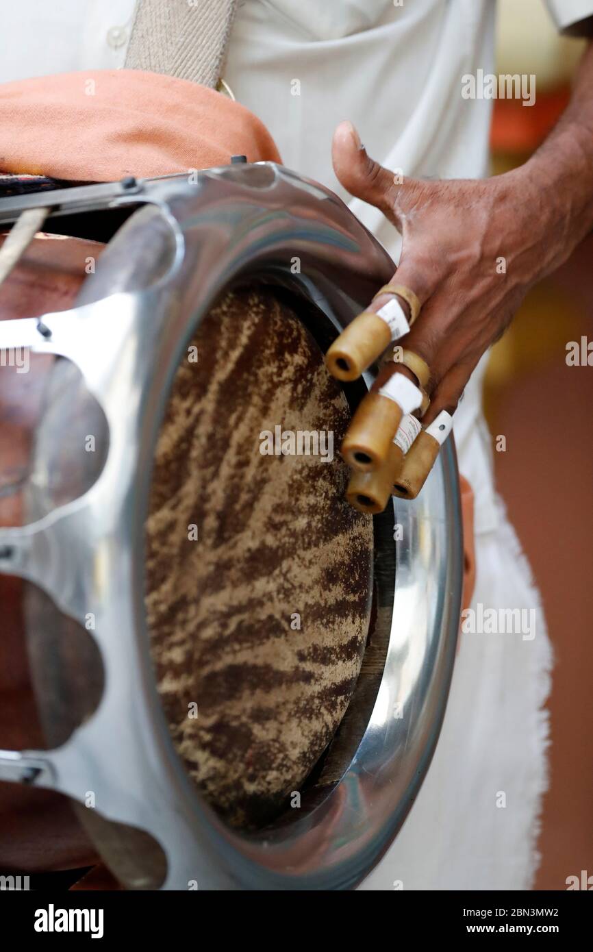 Sri Mahamariamman Hindu Temple. Musician playing a Thavil, a tradional ...