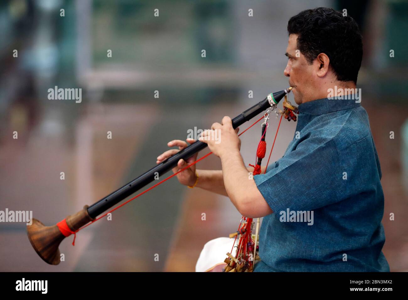 Sri Mahamariamman Hindu Temple. Musician playing a Nadaswaram, a ...