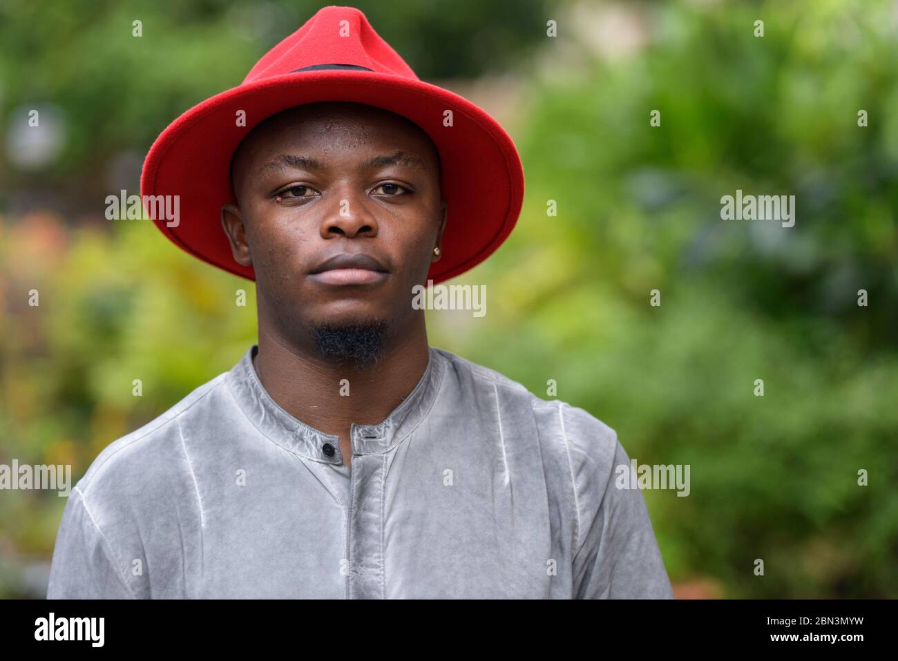 Face of young handsome African man wearing hat outdoors Stock Photo - Alamy