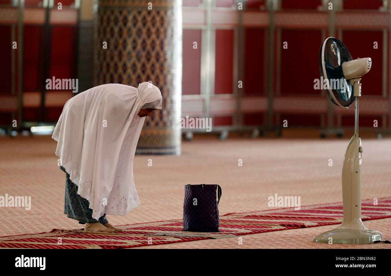 The National Mosque or Masjid Negara. Prayer hall. Muslim woman praying ...