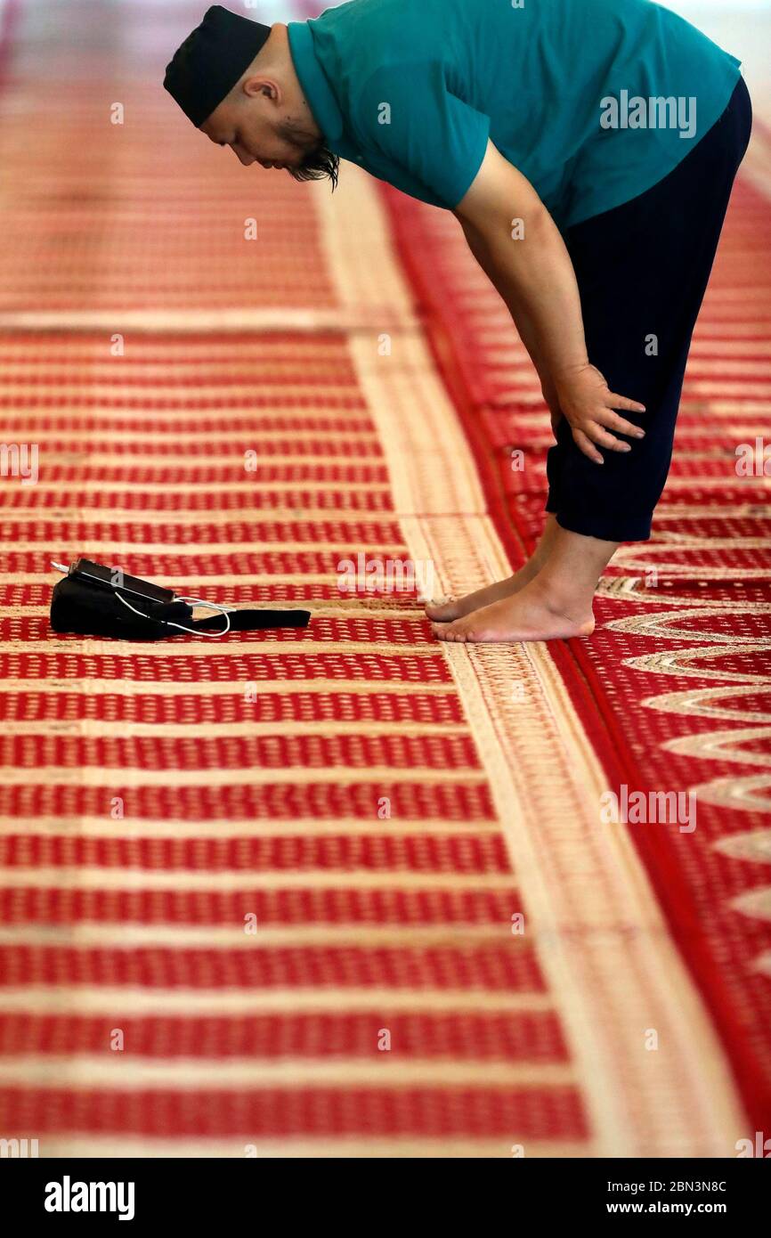 The National Mosque or Masjid Negara. Prayer hall. Muslim man praying ...