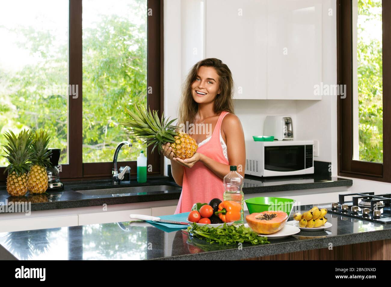 Happy woman housewife during cooking process in the kitchen Stock Photo ...