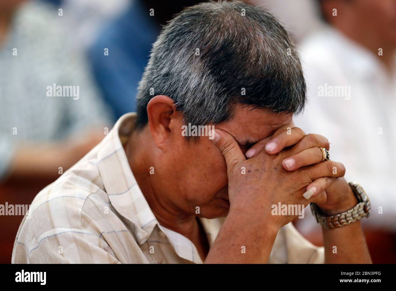 Catholic church. Sunday mass. Man praying. Ho Chi Minh City. Vietnam ...