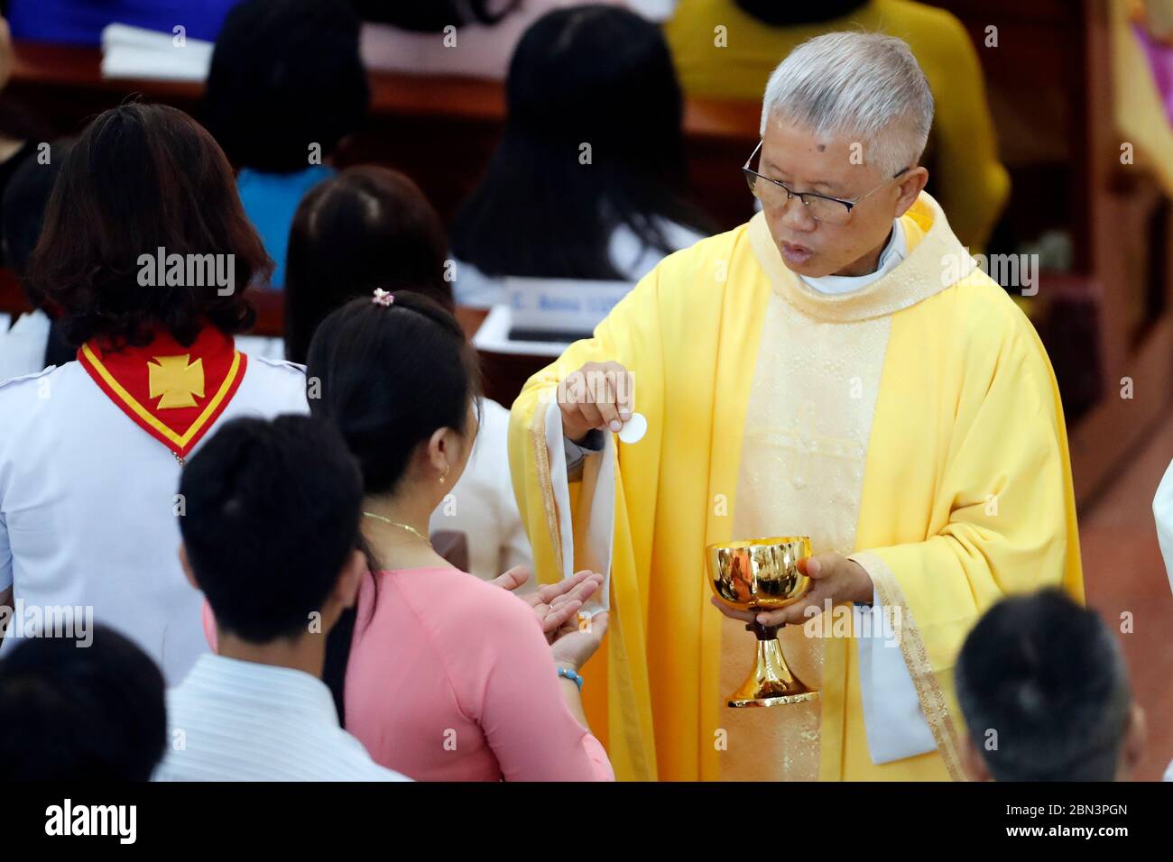 Catholic mass. Catholic mass. Priest giving holy communion. Bien Hoa ...