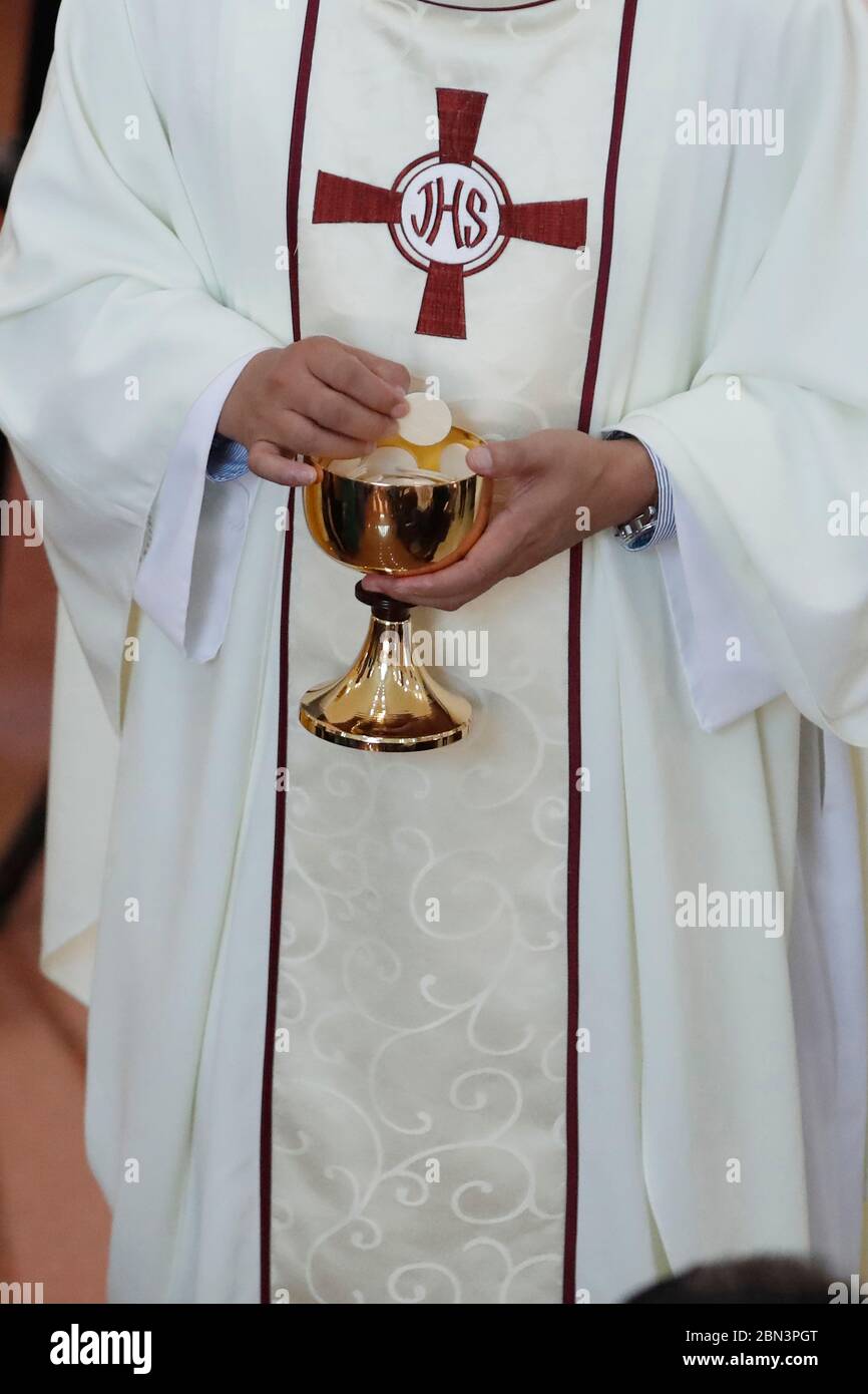 Catholic mass. Catholic mass. Priest giving holy communion. Bien Hoa ...