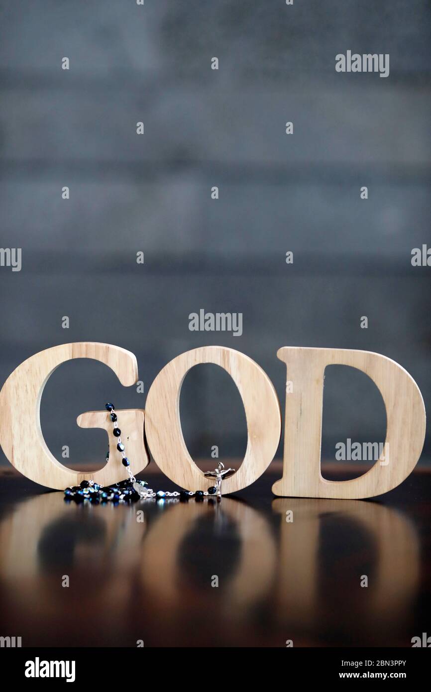 Wooden letters forming the word GOD and Rosary. Christian symbol Stock ...