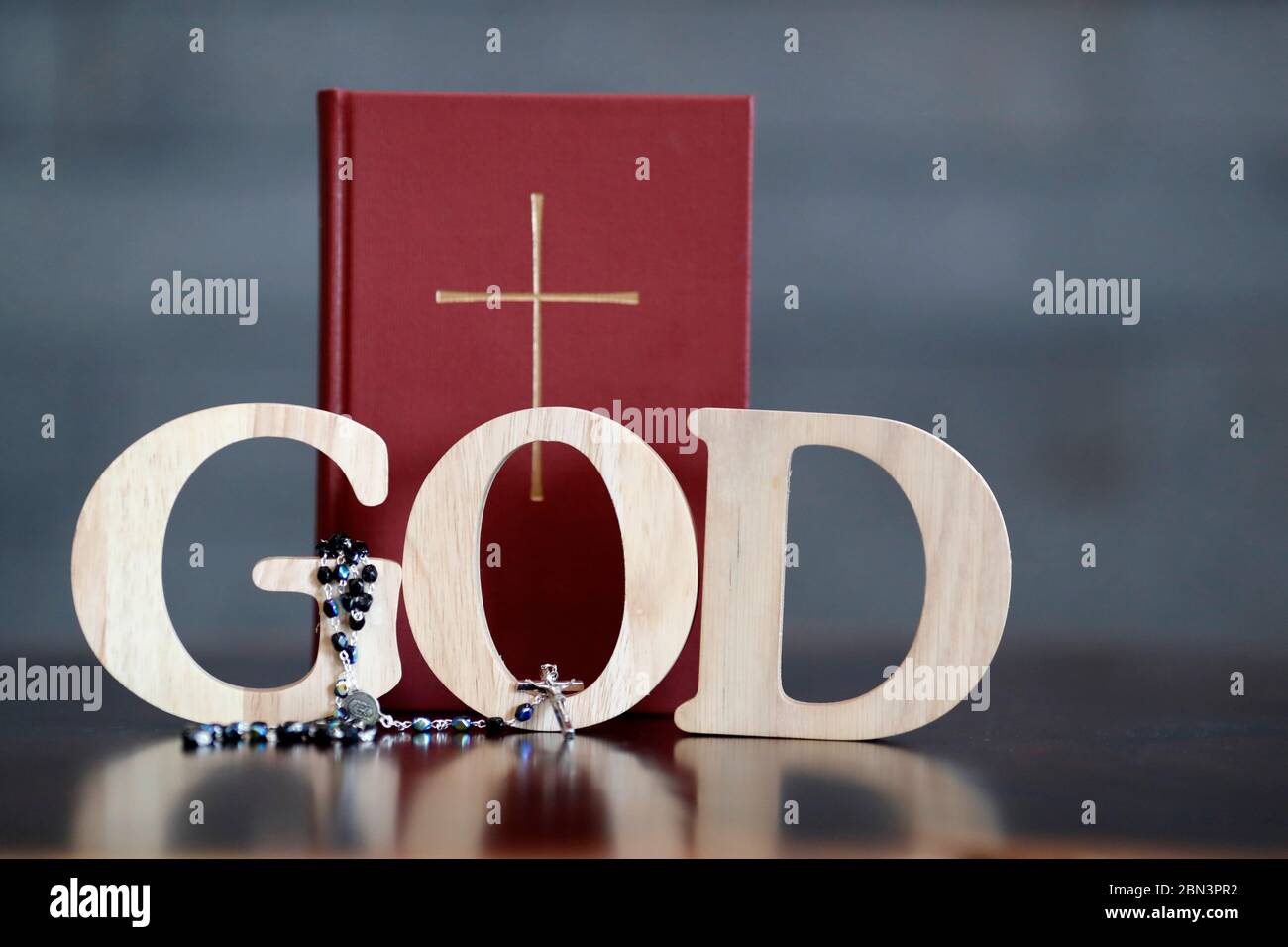 Wooden letters forming the word GOD, Rosary and Bible. Christian symbol ...
