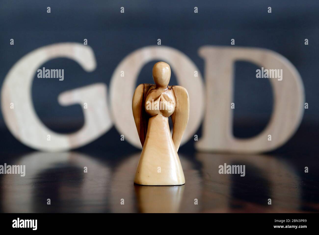 Wooden letters forming the word GOD and angel. Christian symbol Stock ...
