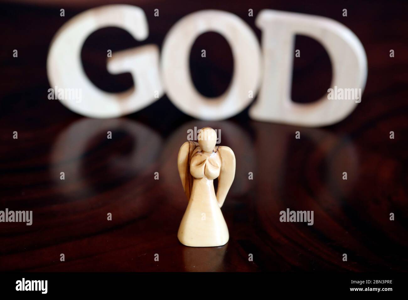 Wooden letters forming the word GOD and angel. Christian symbol Stock ...