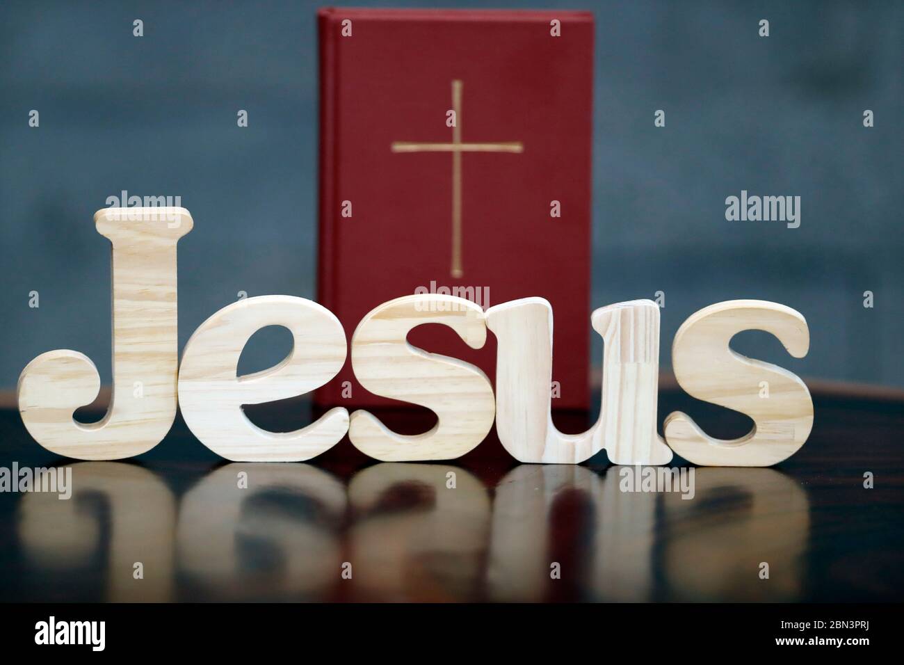 Wooden letters forming the word JESUS and Bible. Christian symbol Stock ...