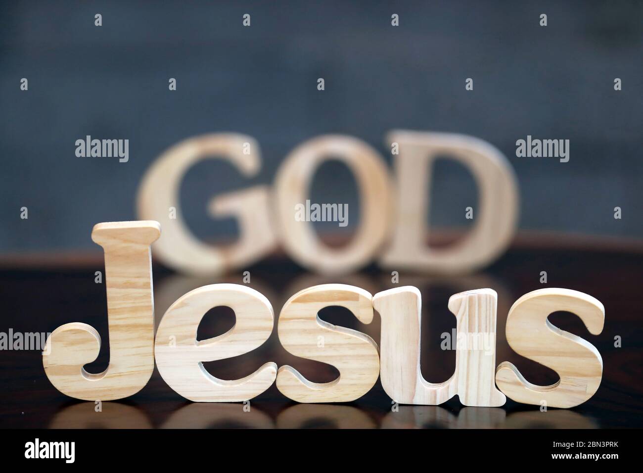 Wooden letters forming the words JESUS and GOD. Christian symbol Stock ...