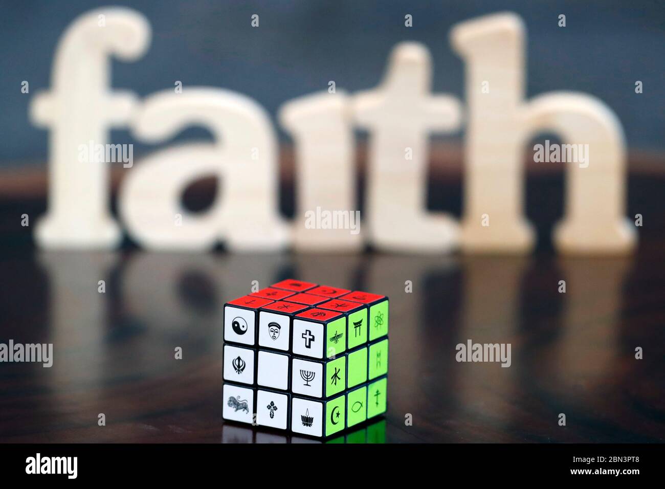 Wooden letters forming the word FAITH and Rubik's cube with religious ...