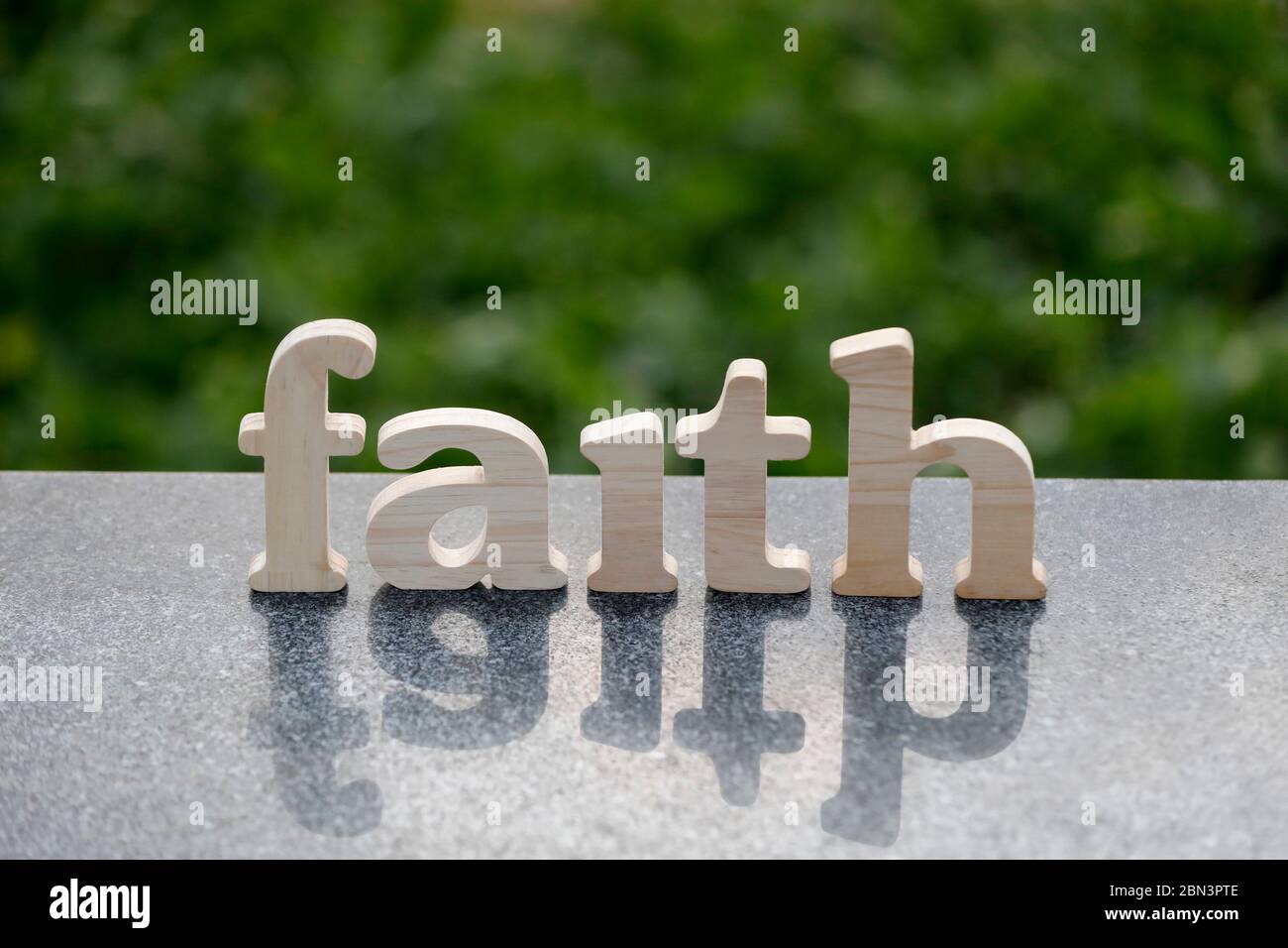Wooden letters forming the word FAITH. Christian symbol Stock Photo - Alamy