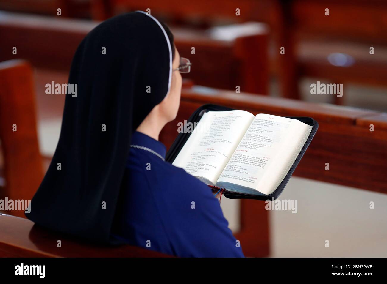 Dominican nun reading the bible. Vietnam Stock Photo - Alamy