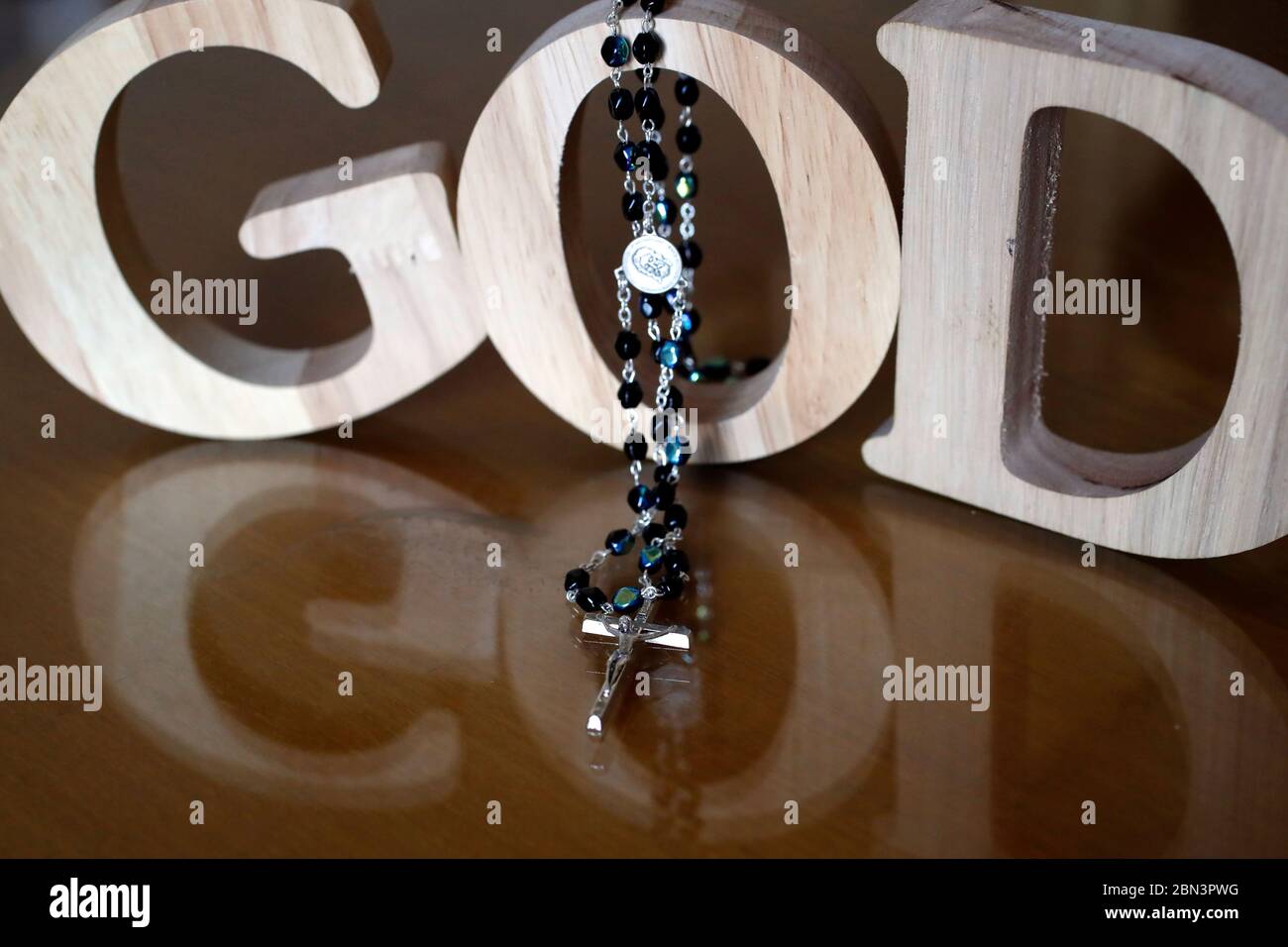 Wooden letters forming the word God and a catholic rosary Stock Photo ...