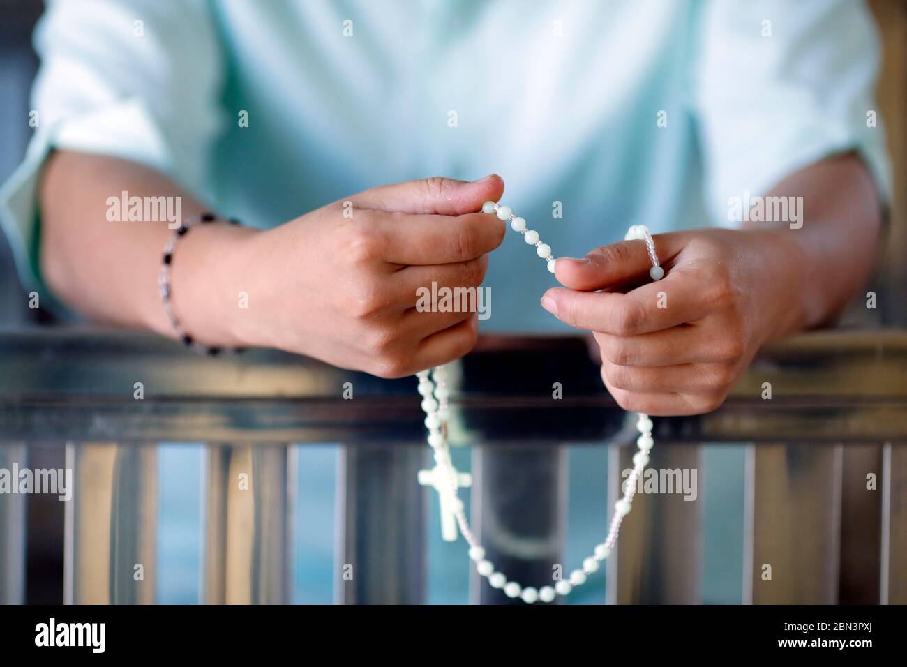 Young catholic woman praying the rosary beads. Vietnam Stock Photo - Alamy