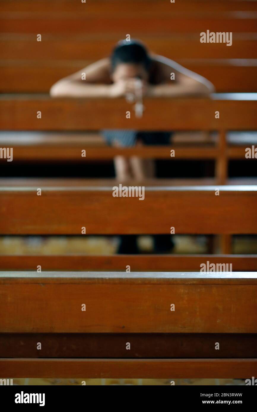 Catholic woman praying alone in a church Stock Photo - Alamy